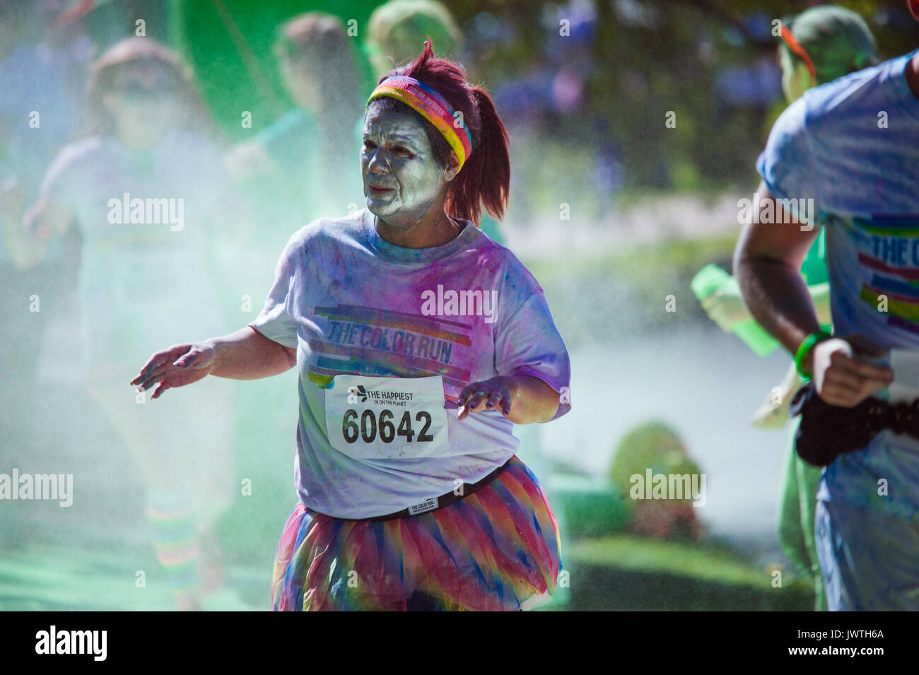 Woman with silver face paint covered in paint and smoke during a Color ...