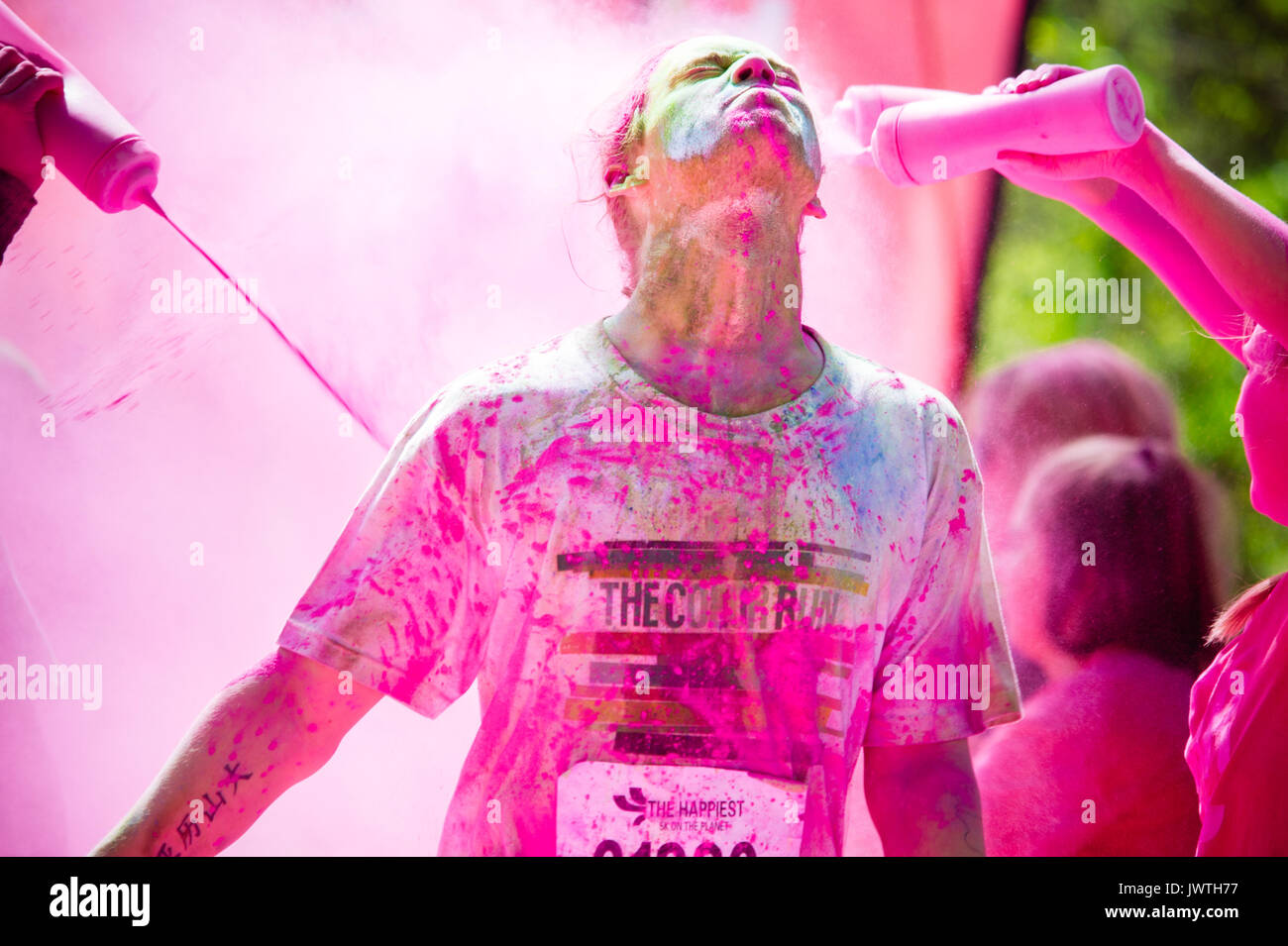 Man covered in paint and smoke during a Color Run Stock Photo - Alamy