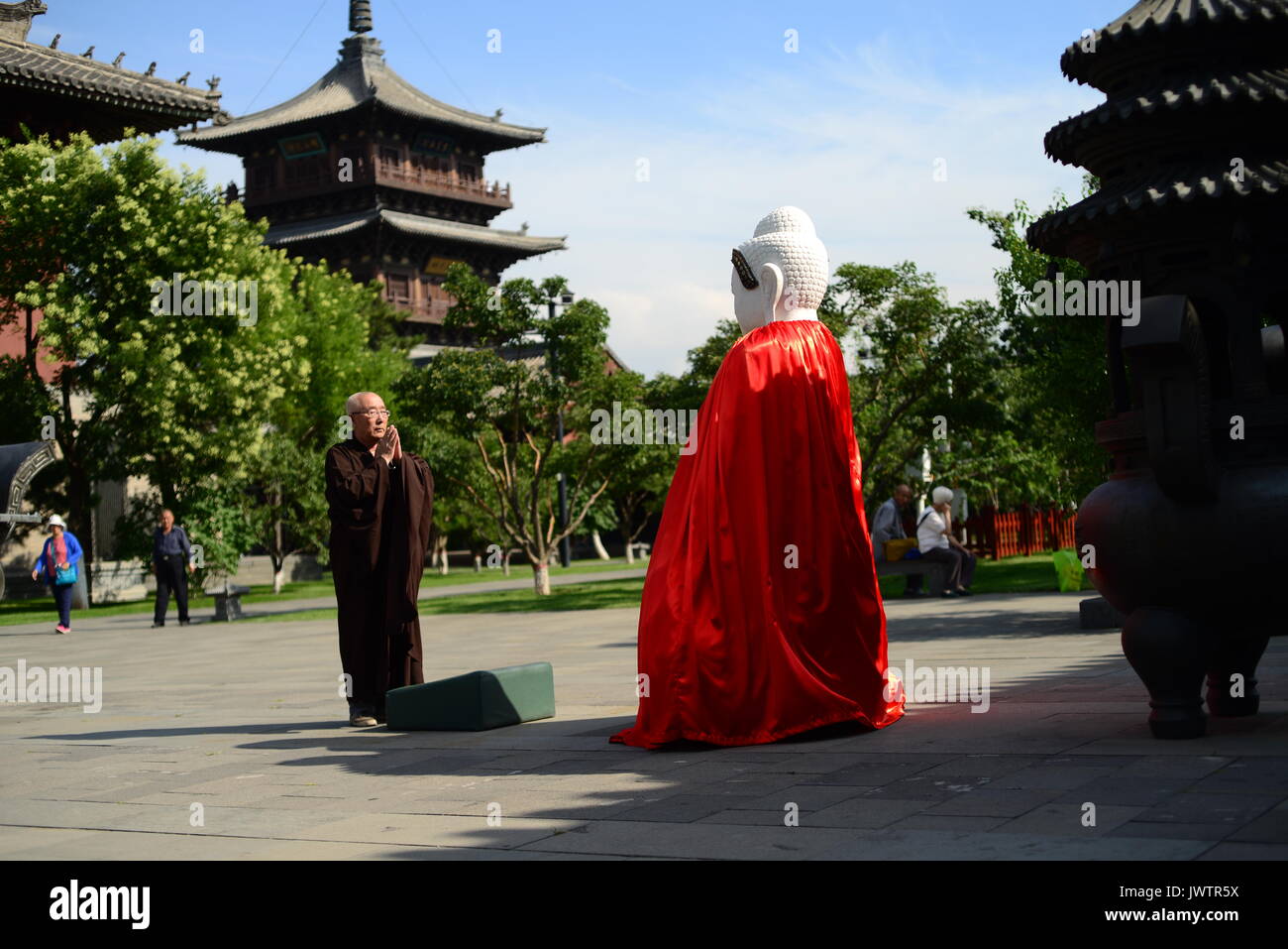 Man praying in front of small Buddah Huayan Temple Datong China Stock ...