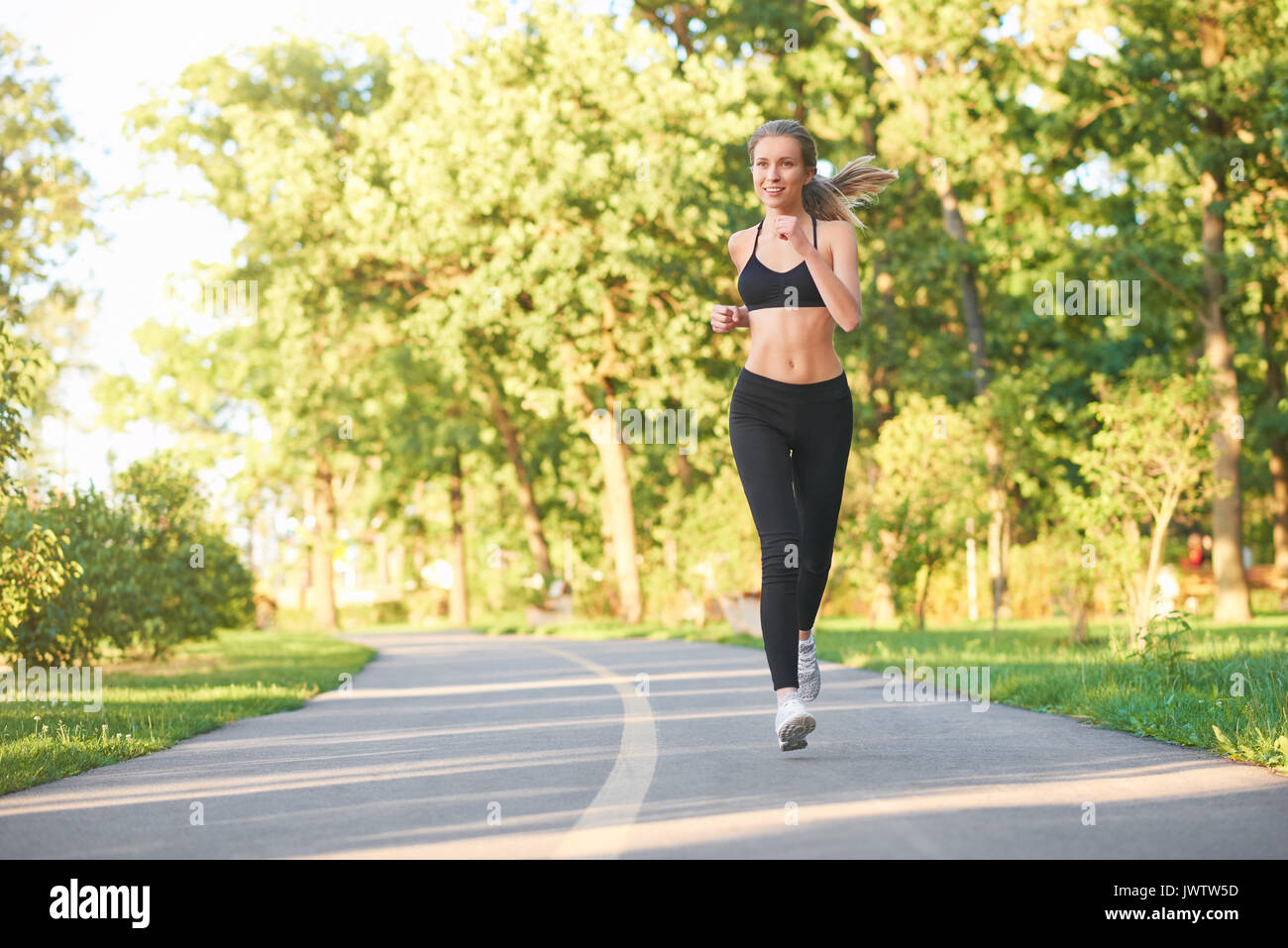 Female runner jogging in the forest Stock Photo - Alamy