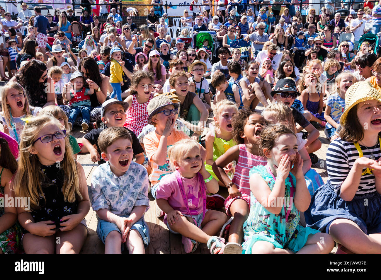 Facing audience of young children, 4-9 years old, sitting crowded ...