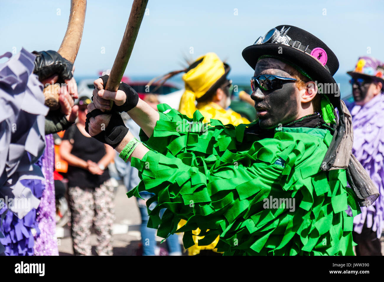 Traditional English folk dancers, Motley Morris team, dancing. Holding ...