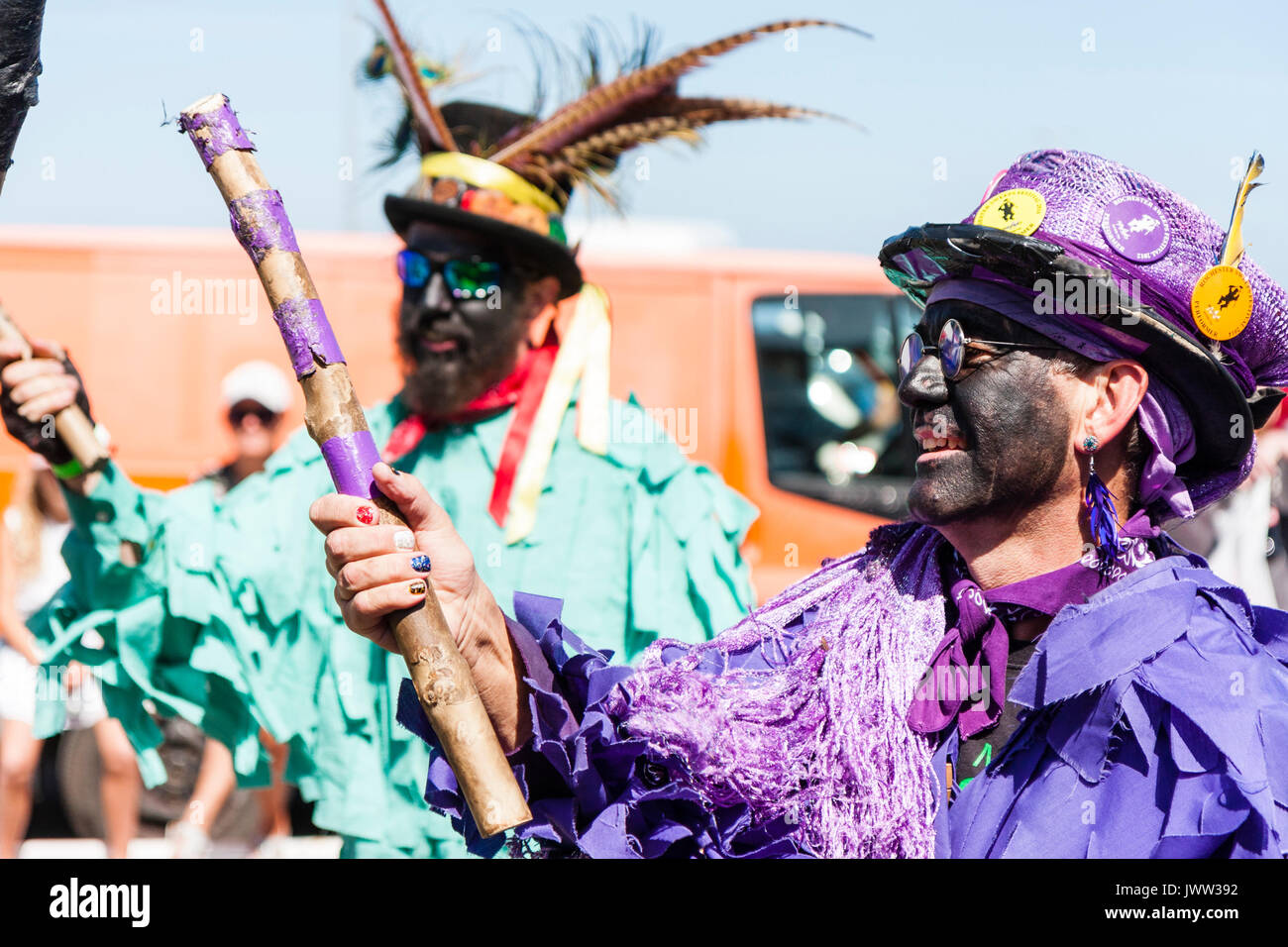Traditional English folk dancers, Motley Morris team, dancing. Holding ...