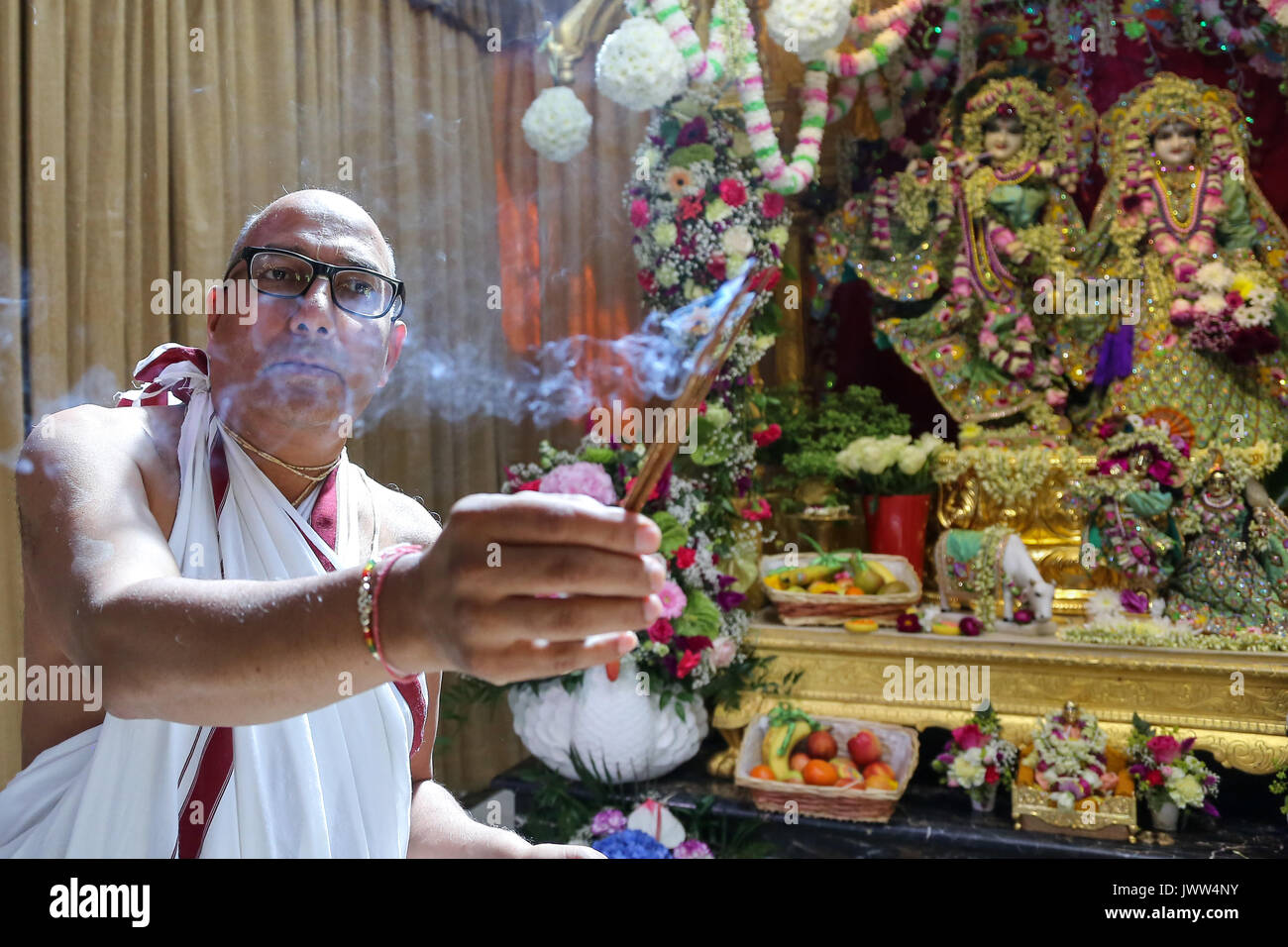 Watford, UK. 13th Aug, 2017. The priest conducts an aarti at ...