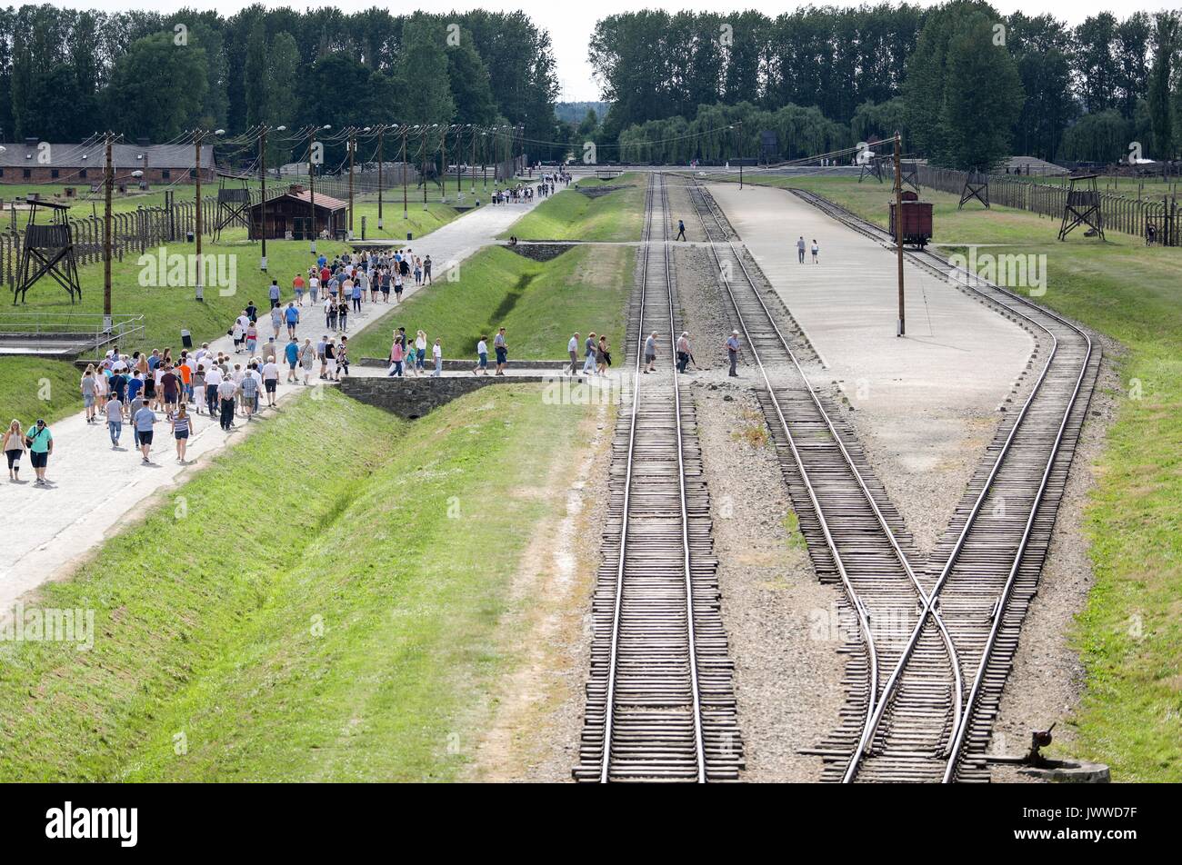 Numerous people walk across the tracks with the infamous ramp during ...