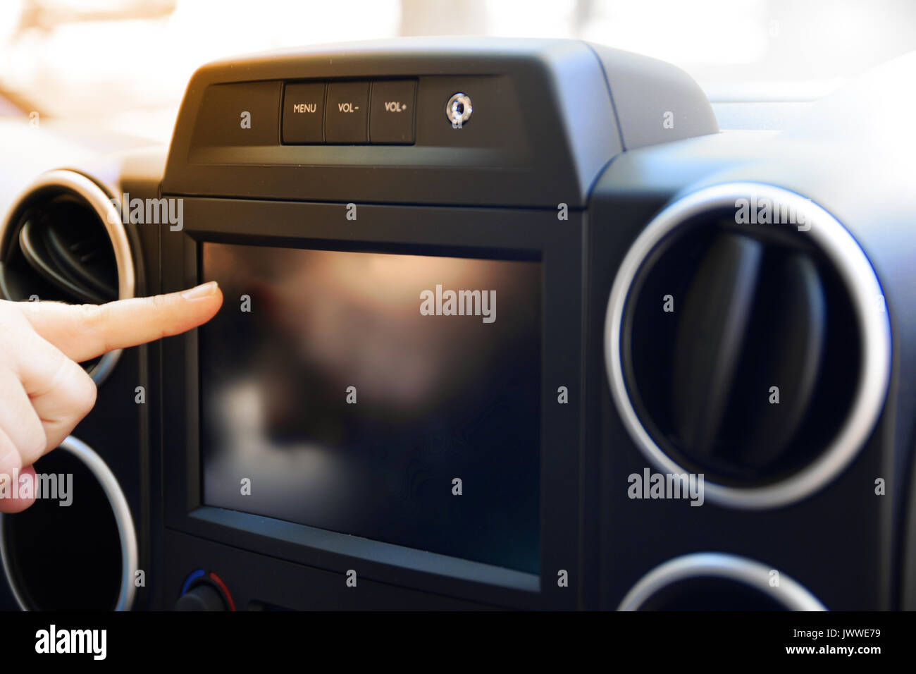 Hand using a mirror screen with GPS system in a autonome car. Empty ...