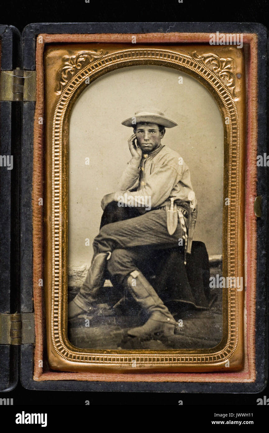 Cowboy, with beaded awl case, boots with spurs, knife and revolver ...