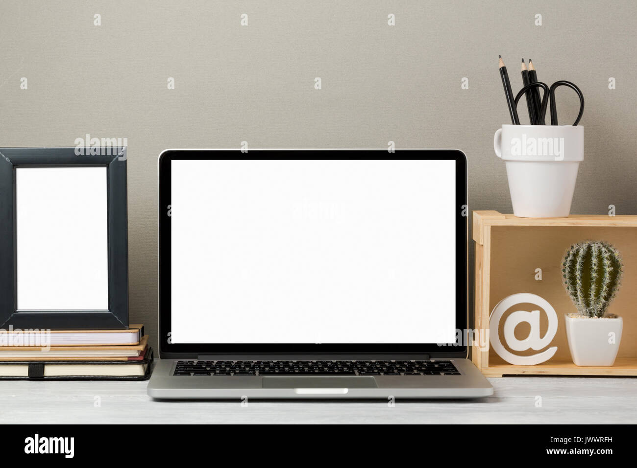 Laptop computer mock up with pencil and photo frame. Modern stylish ...