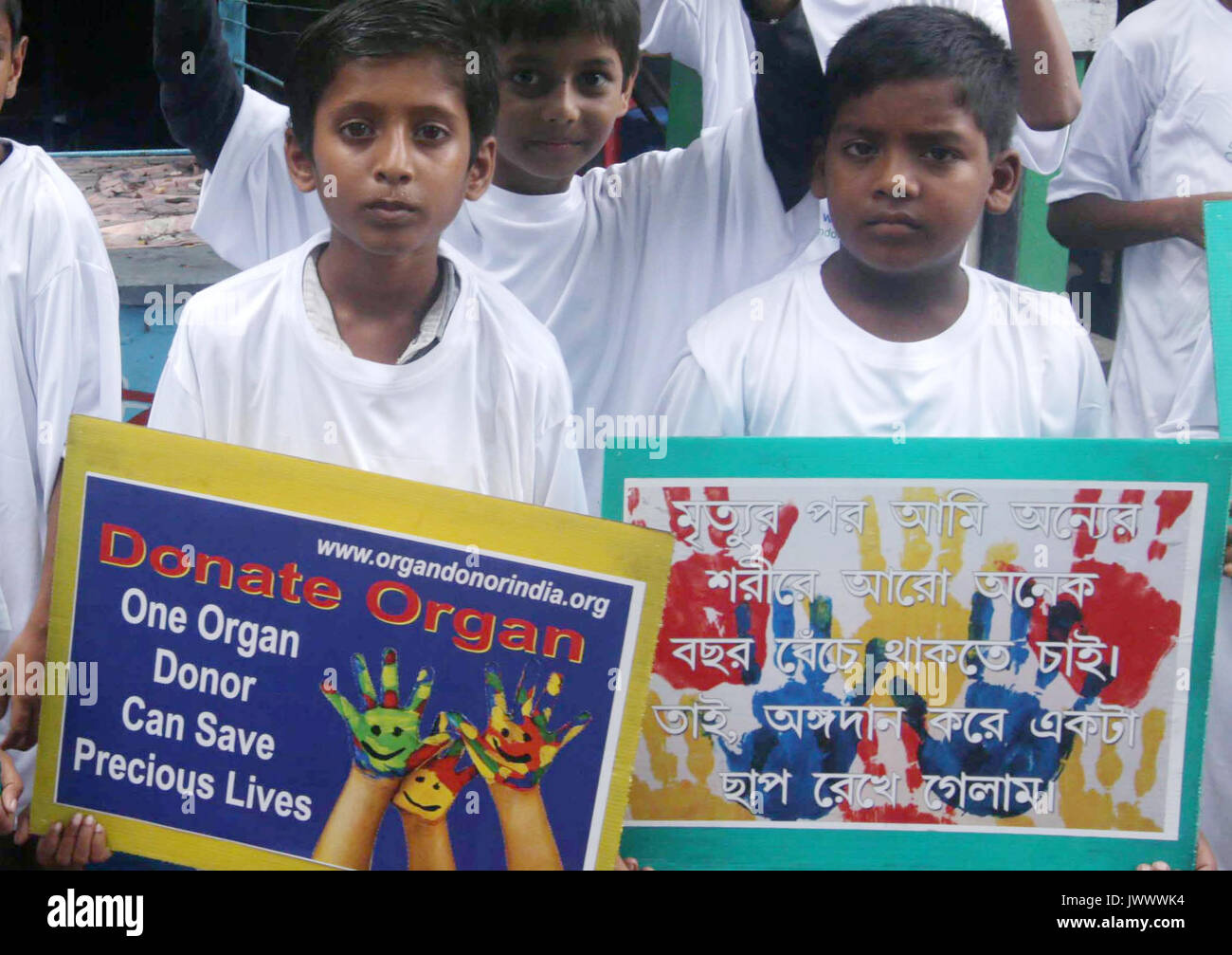 Children hold the poster during the "Organ Donation Day" awareness ...