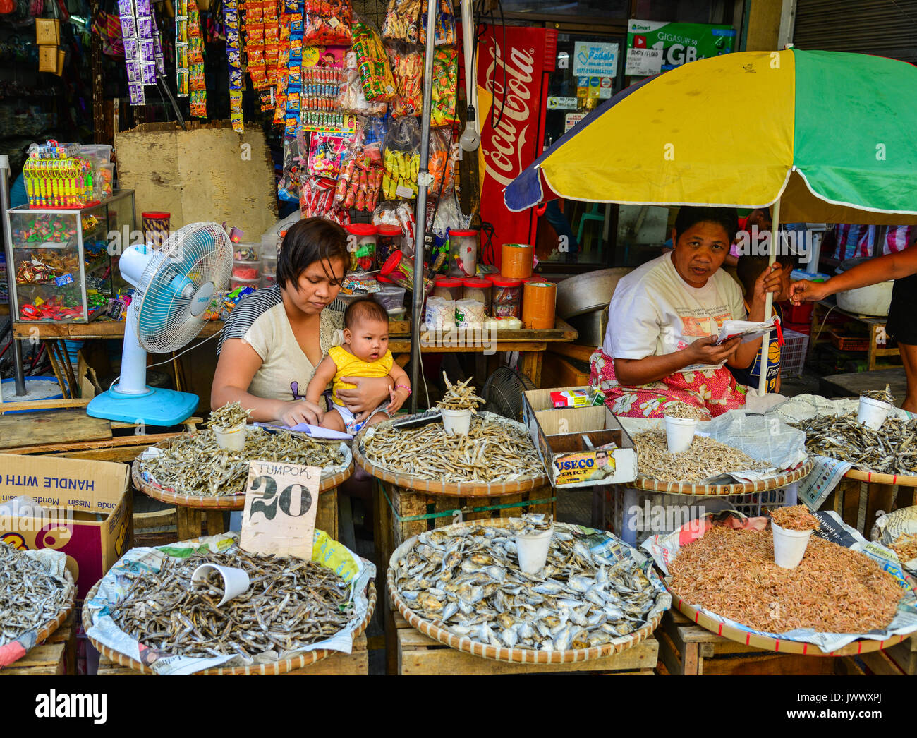 Manila, Philippines - Apr 12, 2017. People sell dried fish at street ...