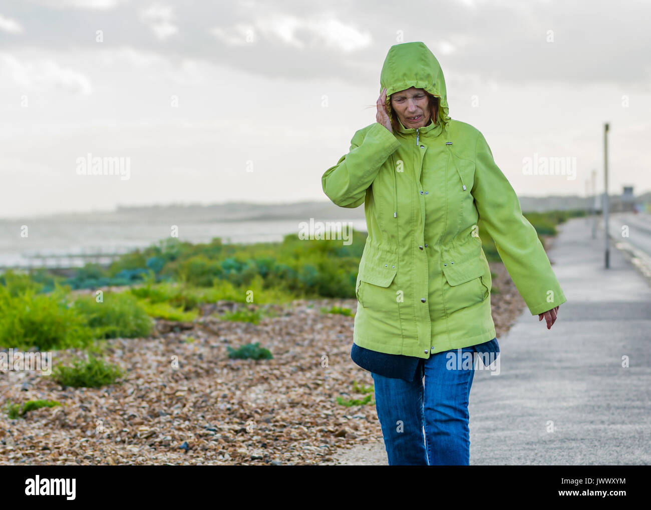 Woman in rain coat hi-res stock photography and images - Alamy