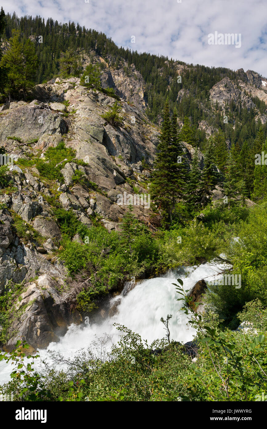 Large granite cliffs rising above a small waterfall along Granite Creek ...