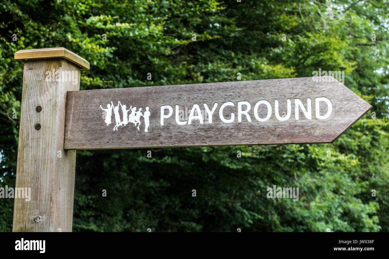 Wooden sign with an icon of children etched alongside 'playground ...