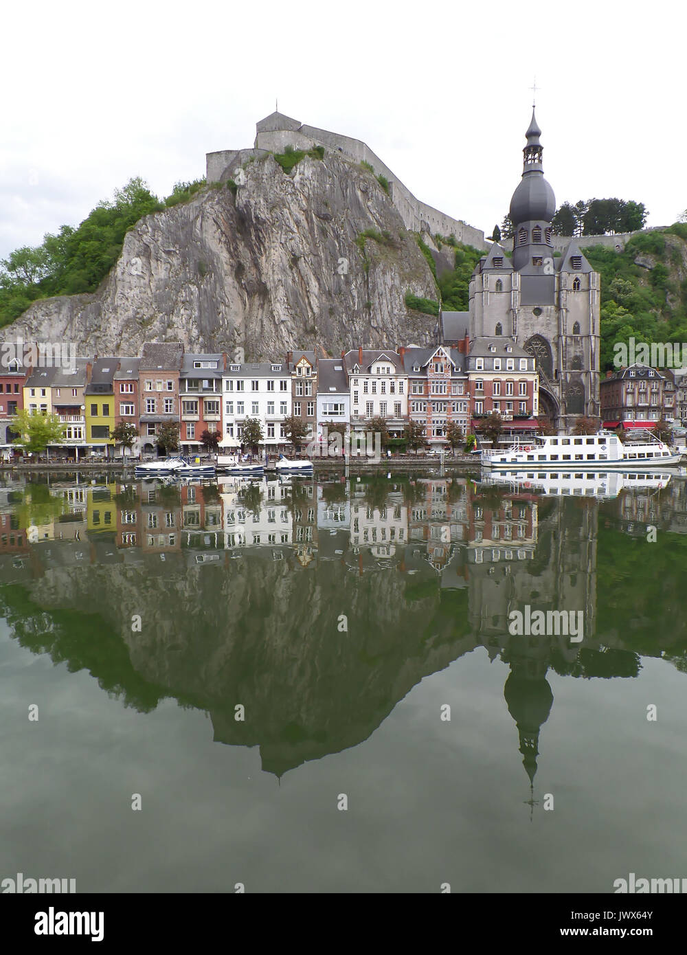 Reflections of gorgeous church and architecture on the Meuse river at ...