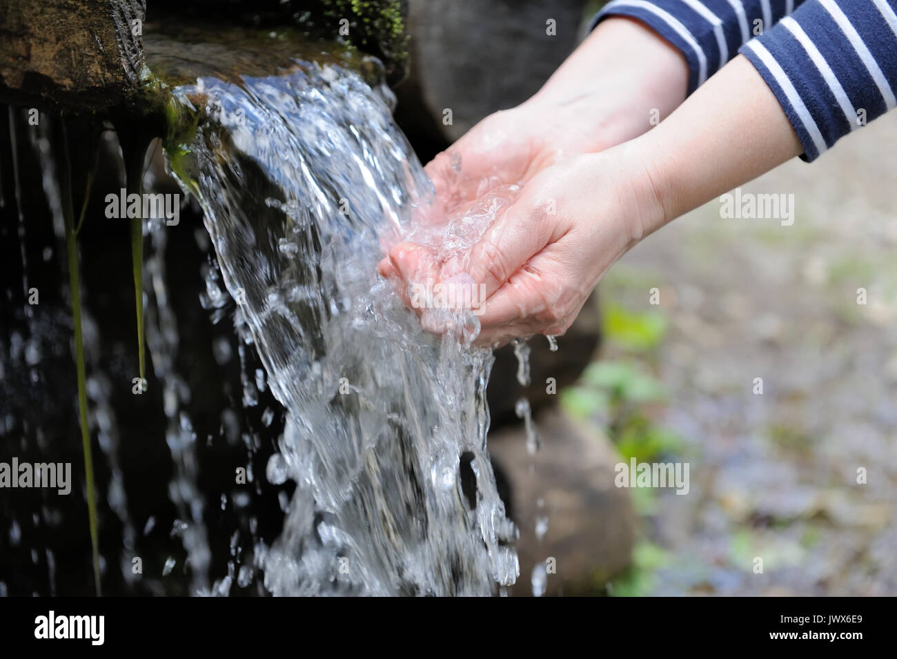 Female hand in water stream hi-res stock photography and images - Alamy