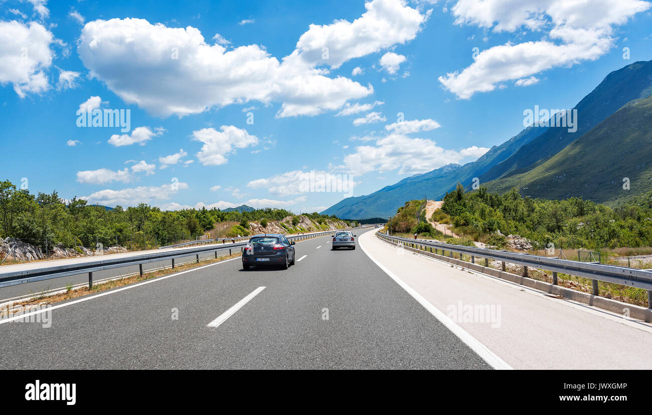Cars speeding on the Autobahn among mountain scenery Stock Photo - Alamy