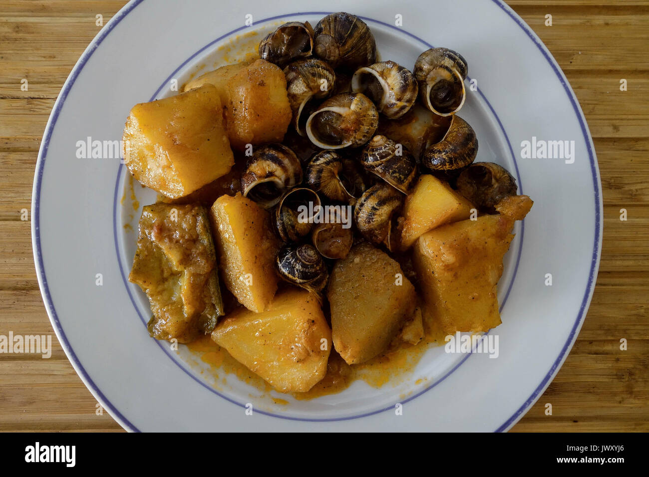 Greek Cuisine. Cooked Snails with Roast Potatoes, Cretan Style Stock ...