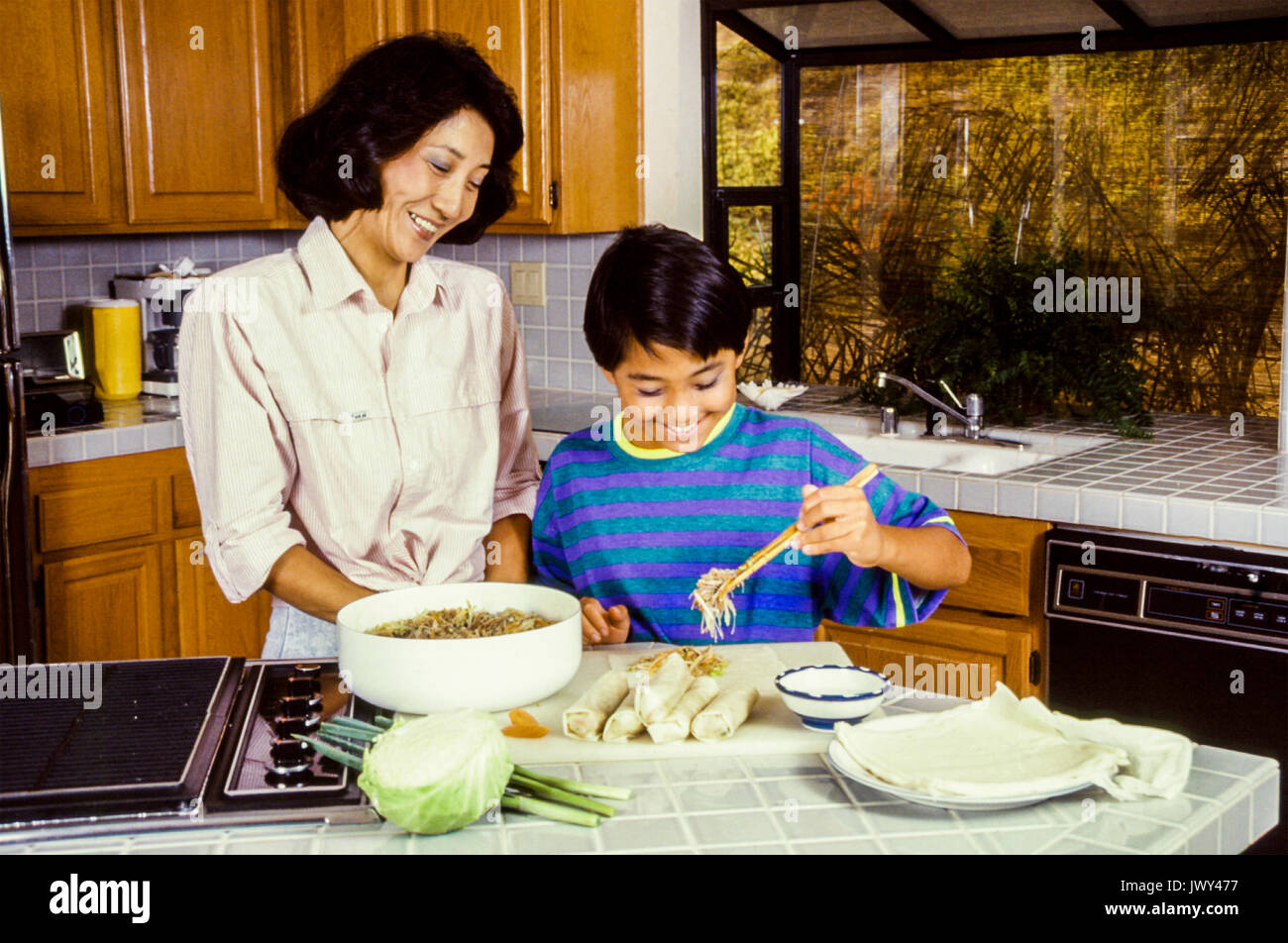 Chinese mom and son cooking in kitchen hi-res stock photography and ...