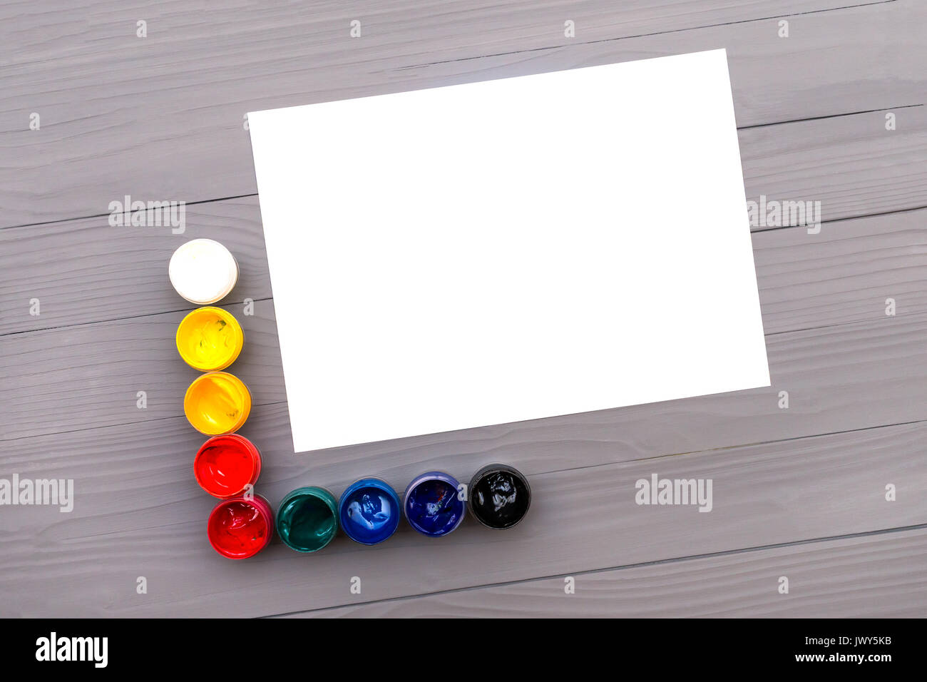 Colored paints and sheet of paper Stock Photo - Alamy