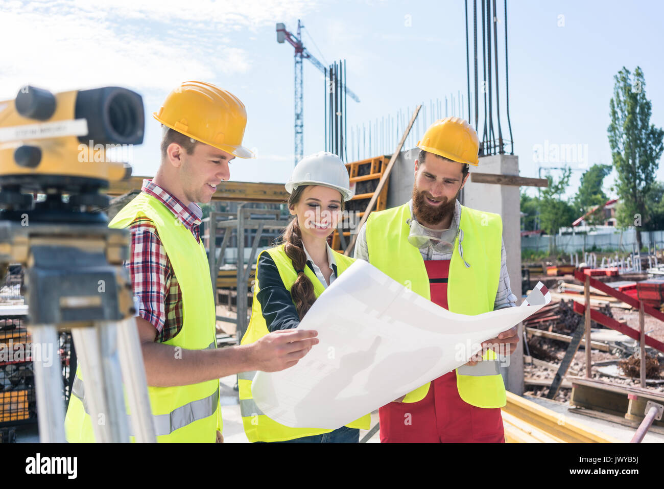 architect sharing ideas about plan of building project on construction ...