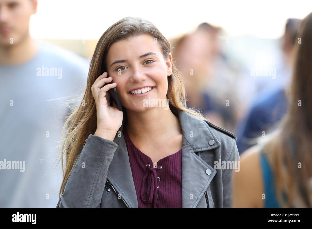 Woman phone call outside happy looking at camera hi-res stock ...