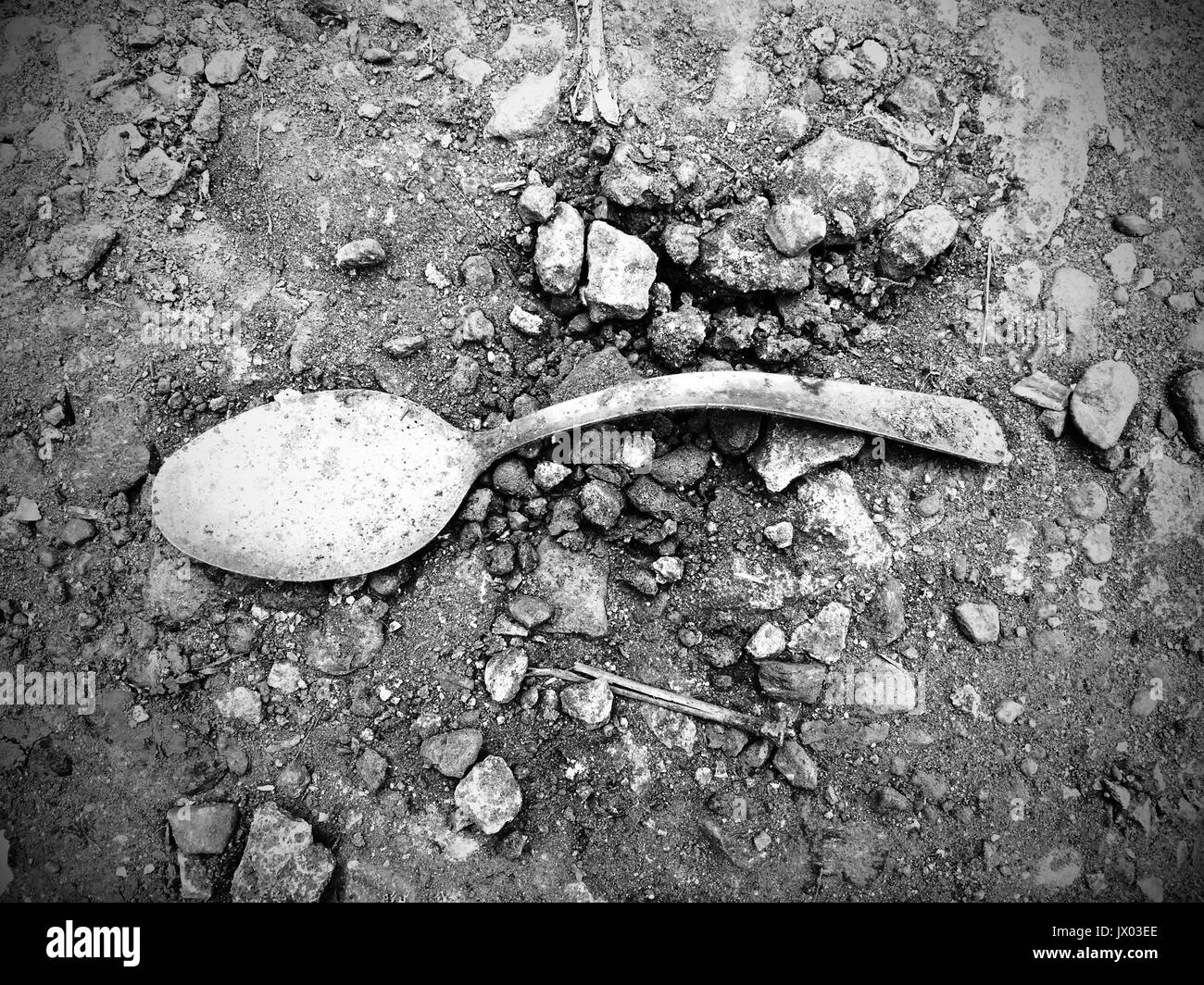 A distorted and dirty spoon in the ground is a fitting symbol of ...