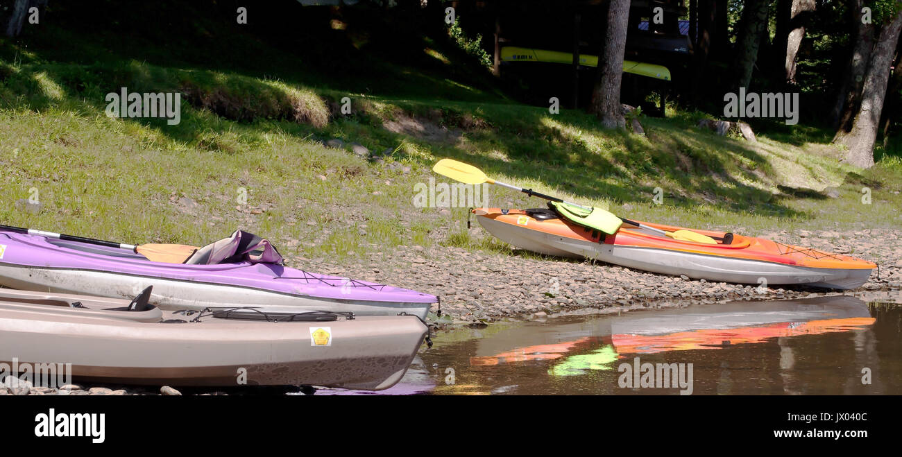 Three kayaks on the river bank Stock Photo - Alamy