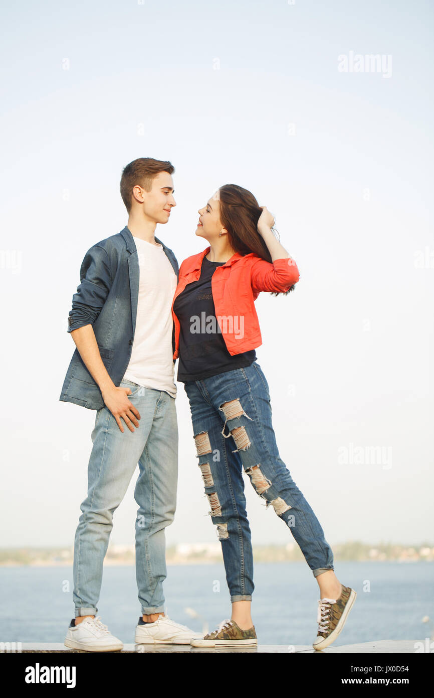 First love. Teenagers on a date. The guy and the girl look into each ...