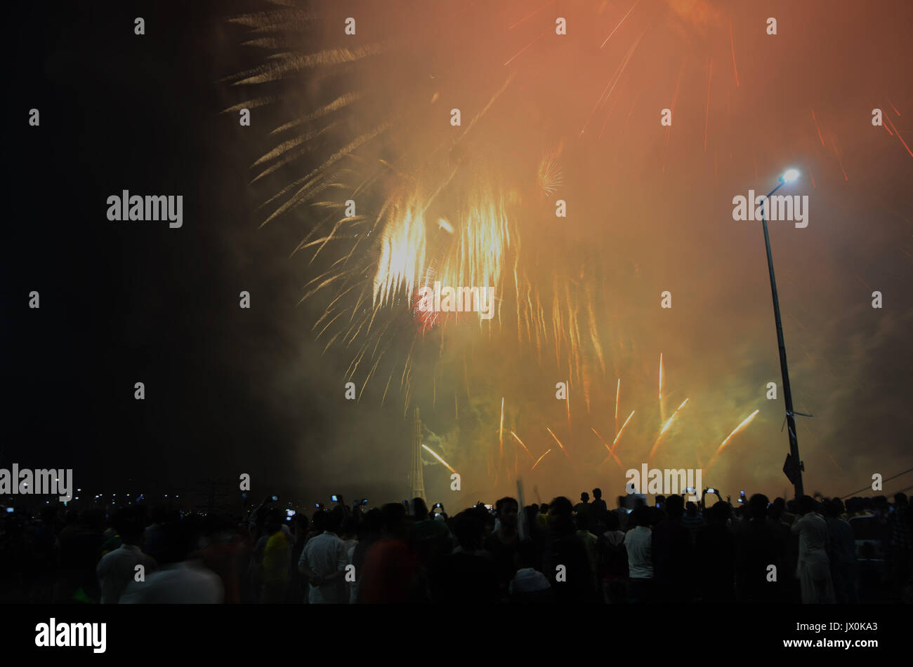 Lahore, Pakistan. 14th Aug, 2017. Pakistani people watch fireworks on ...