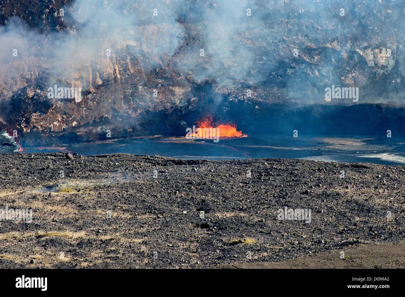 Red hot lava, steam, smoke and fire from the Kilauea volcano at the rim ...