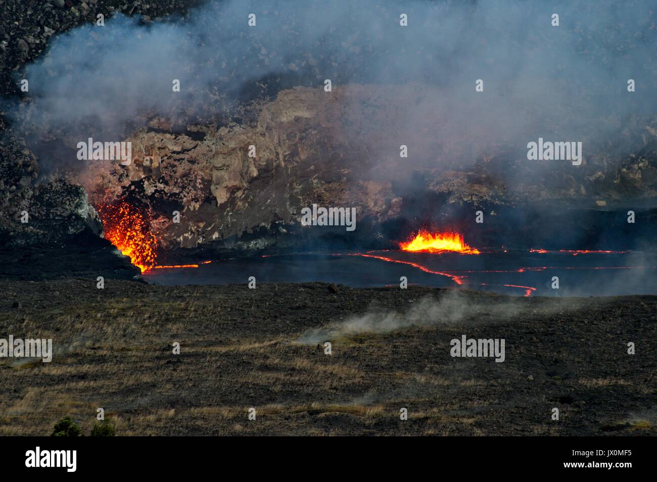 Red hot lava, steam, smoke and fire from the Kilauea volcano at the rim ...