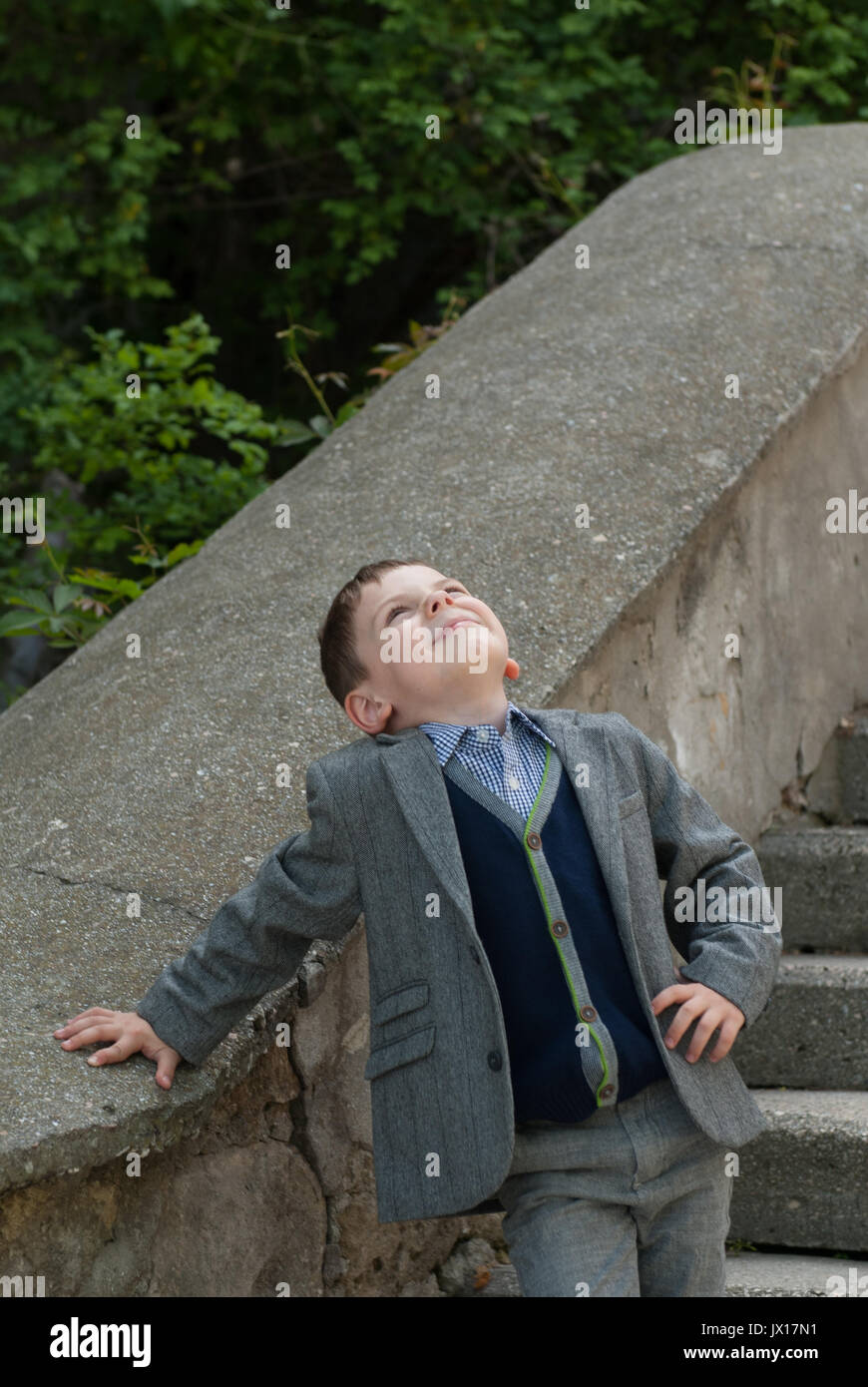 Funny little boy looking up with a smile Stock Photo - Alamy
