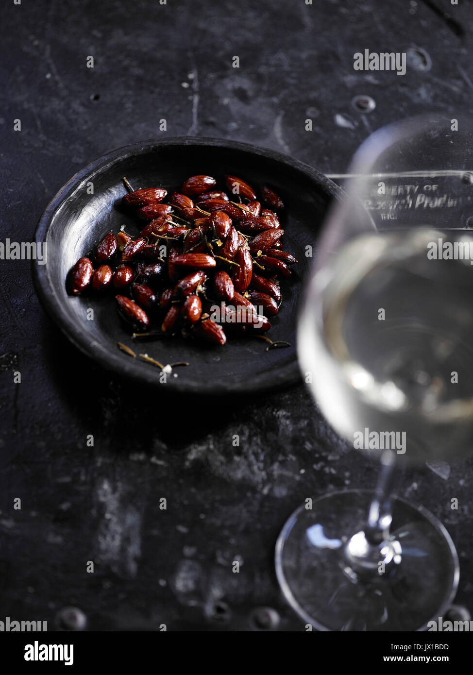 Roasted almonds and glass of wine Stock Photo - Alamy