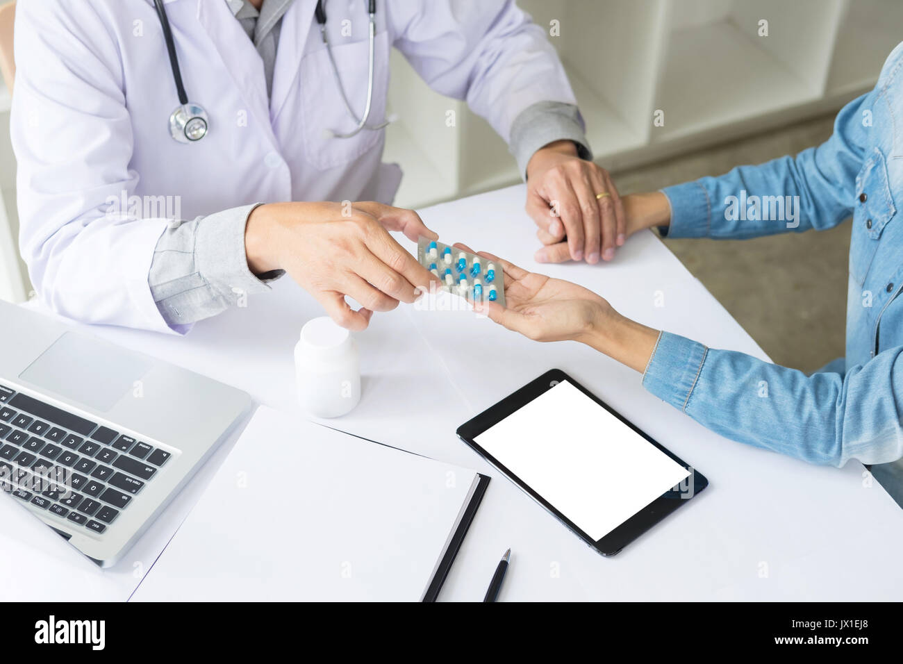 Female doctor hand holding tablet to patient in hospital room Stock ...