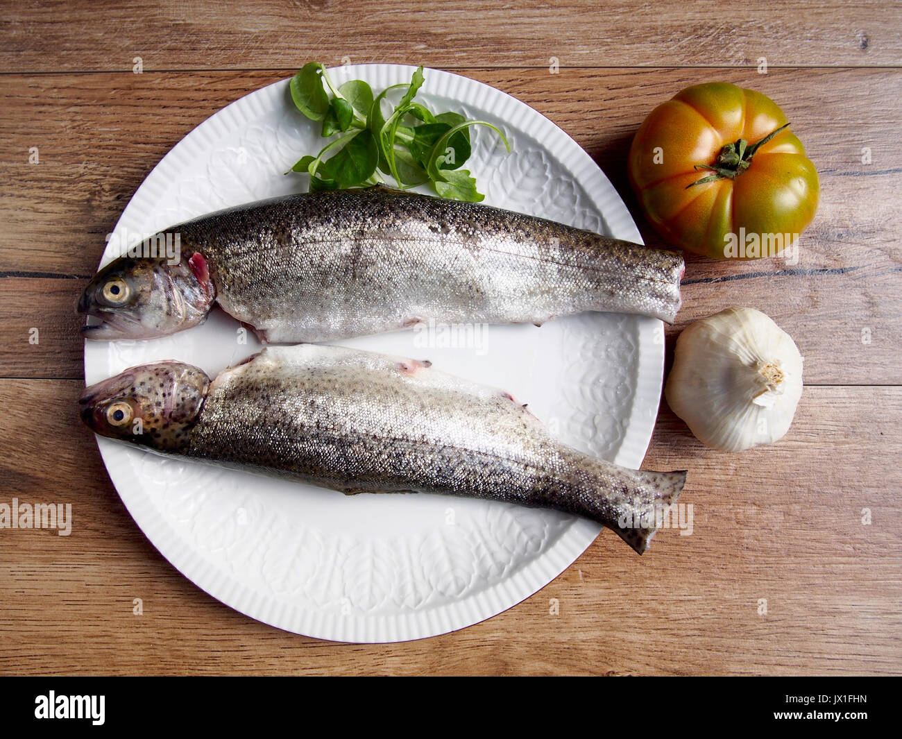two raw trout in a plate Stock Photo - Alamy