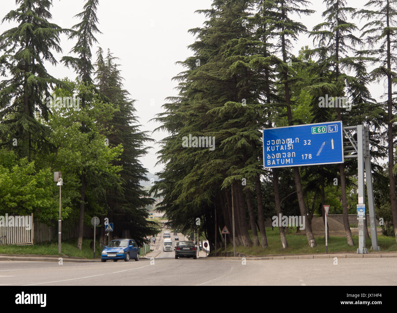 Traffic signs in two alphabets, Latin and Georgian, Directions on an ...