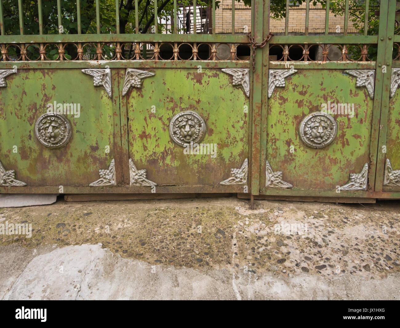 Ornamental iron gate, colourful but rusty in a suburb of Kutaisi ...
