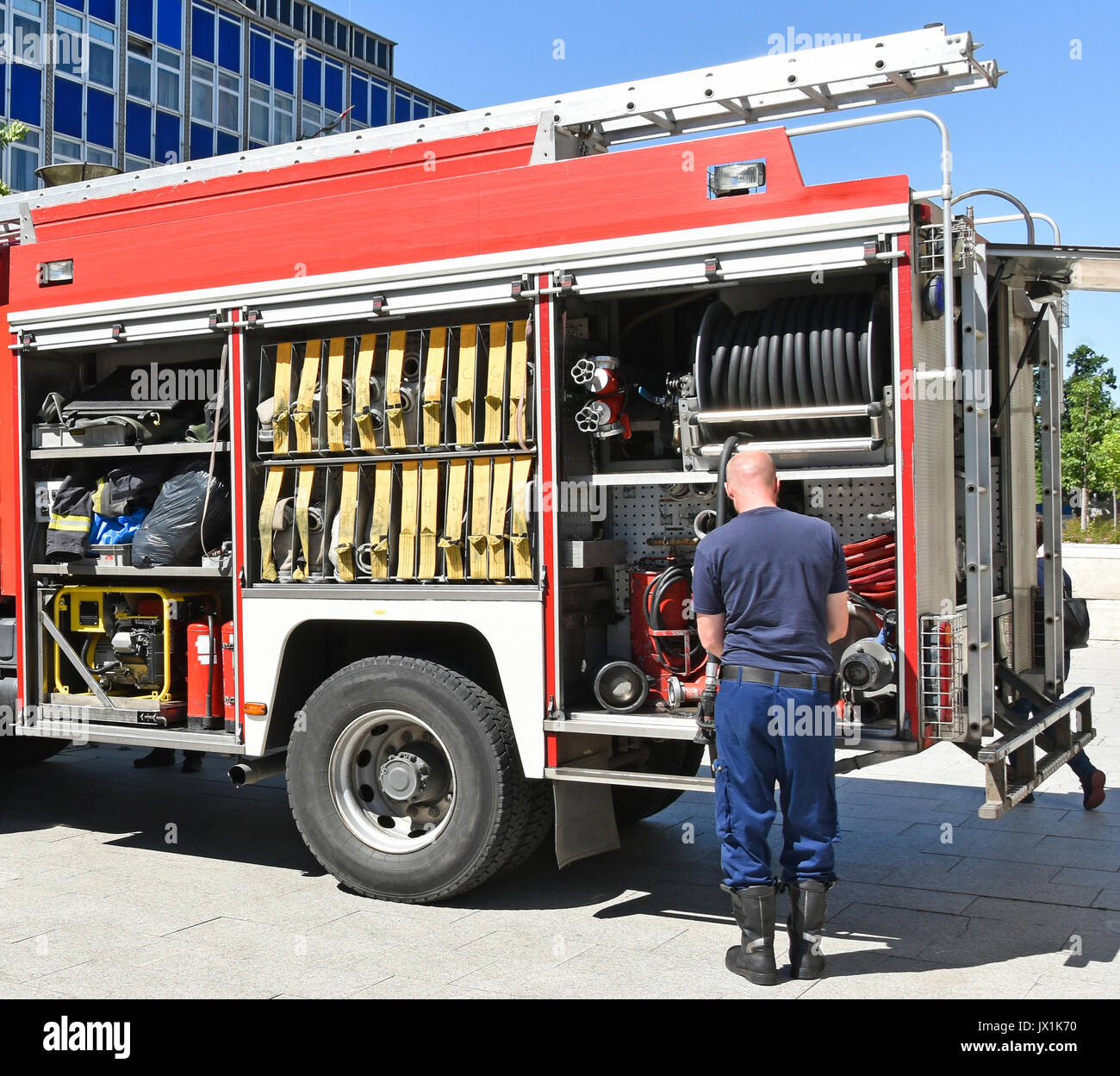 Firefighter next to a firetruck Stock Photo - Alamy