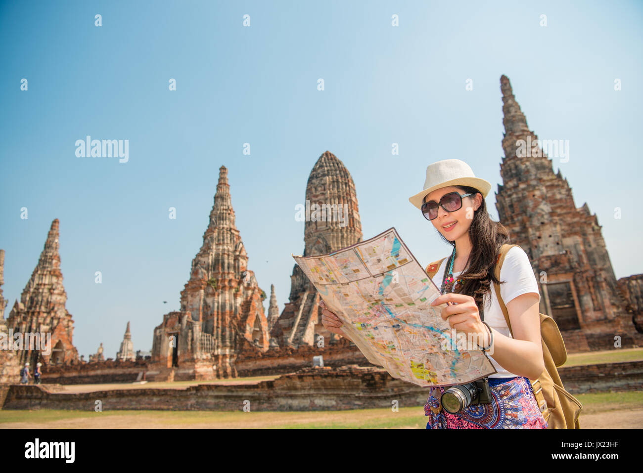 Asian tourist woman with map paper searching for attractions traveling ...