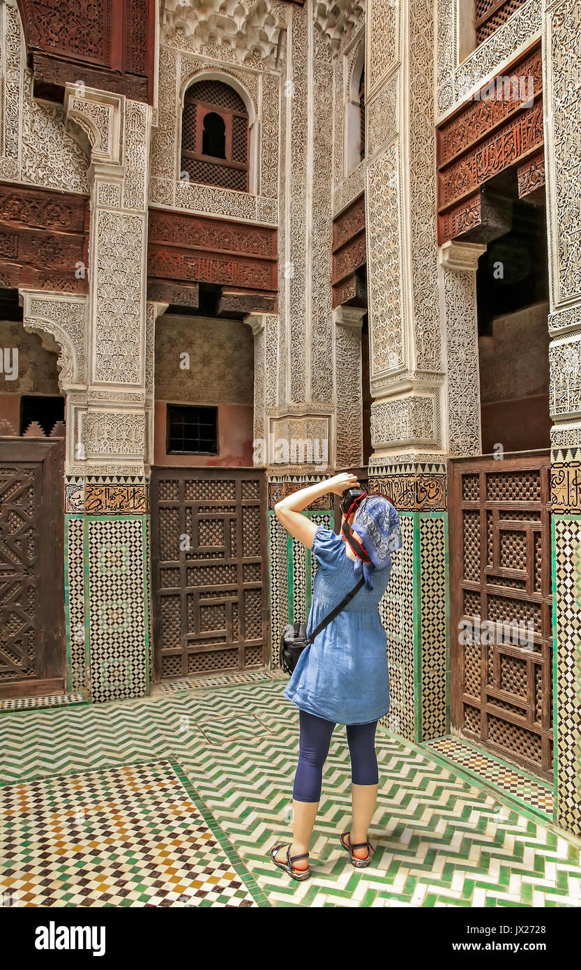 Woman taking pictures of the beautiful artwork inside the Koranic ...