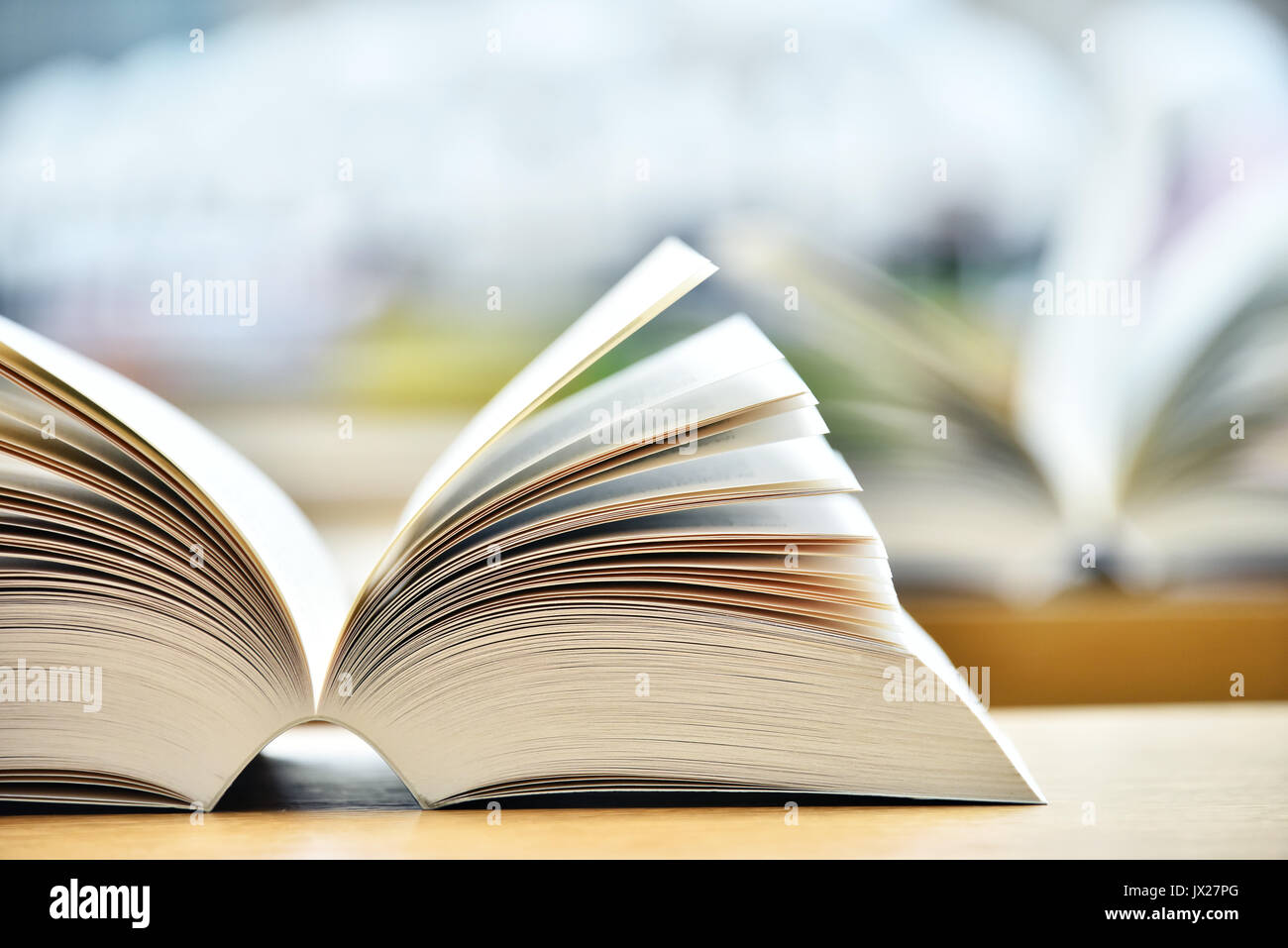 Books lying on the table in the public library Stock Photo - Alamy