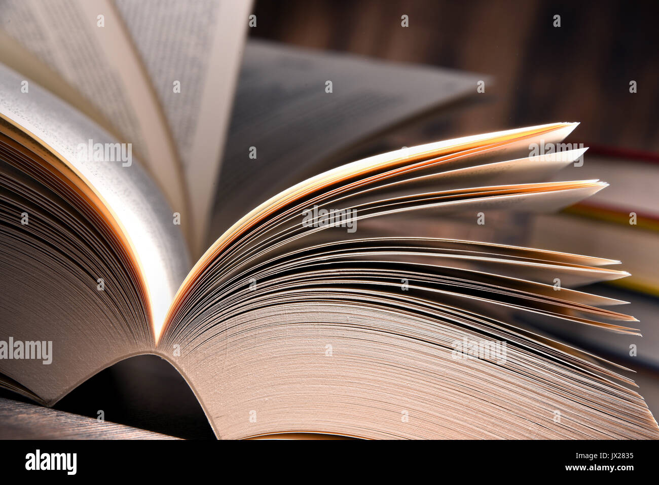 Composition with open book on the table Stock Photo - Alamy