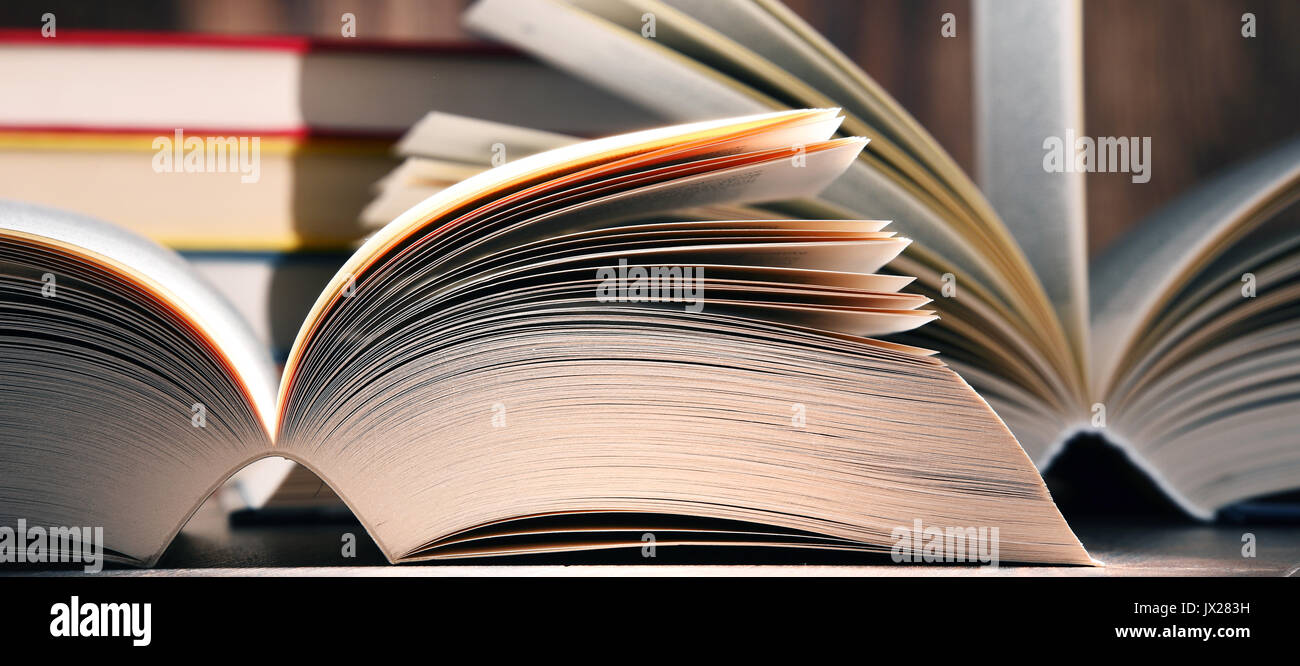 Composition with open book on the table Stock Photo - Alamy