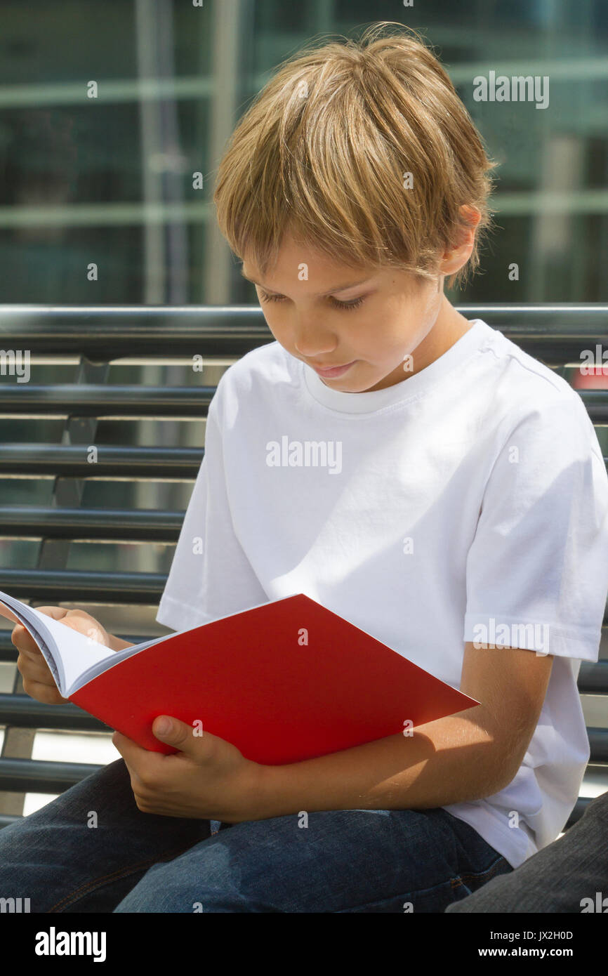 Child flipping through book pages outdoors Stock Photo - Alamy