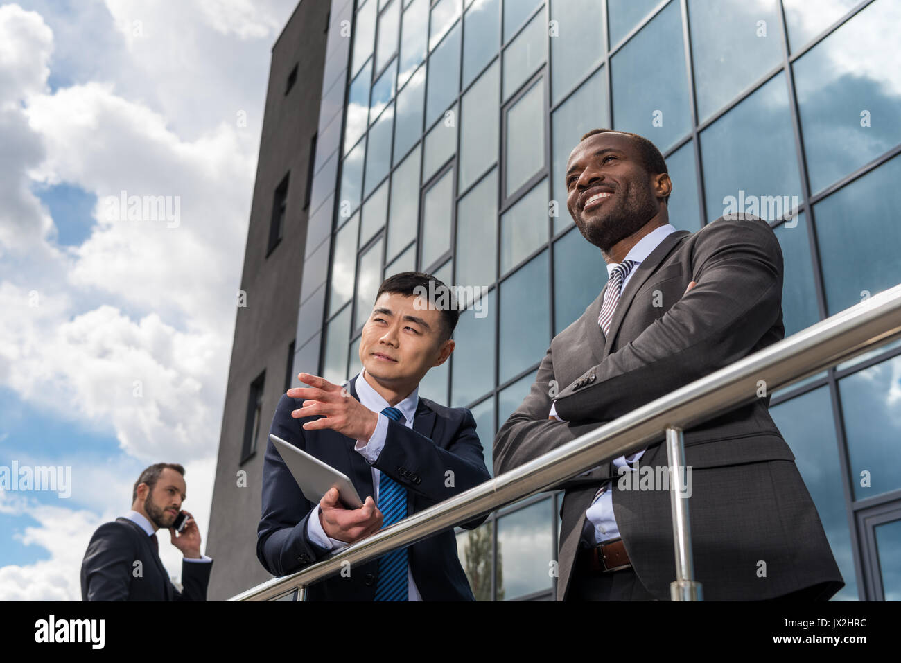 multicultural business team meeting outdoors near office building Stock ...