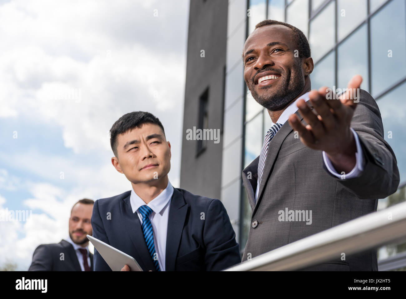 multicultural business team meeting outdoors near office building Stock ...