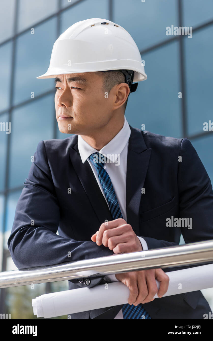 portrait of professional architect in hard hat holding blueprint Stock ...