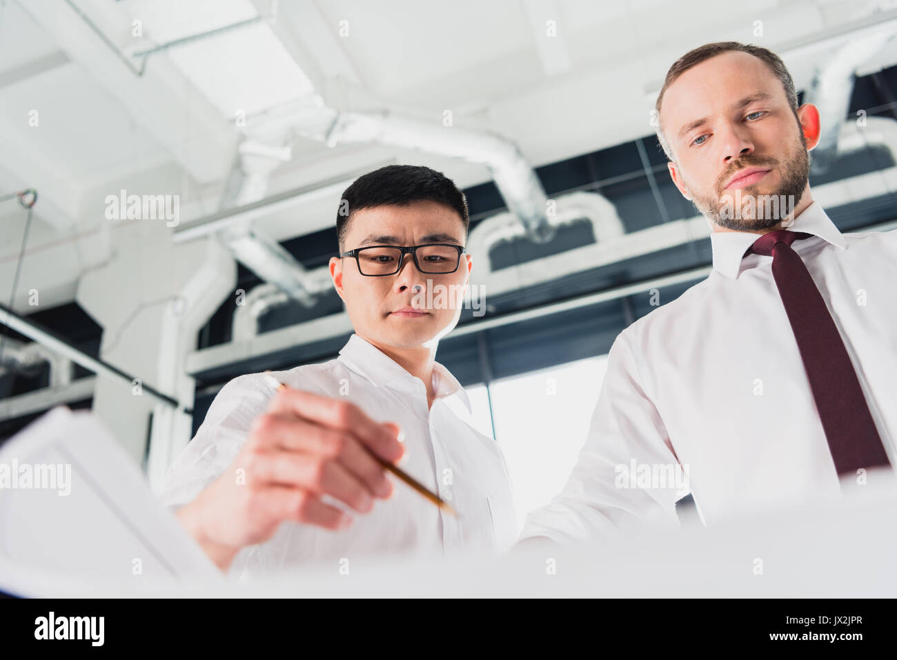 Two businessmen with blueprints hi-res stock photography and images - Alamy