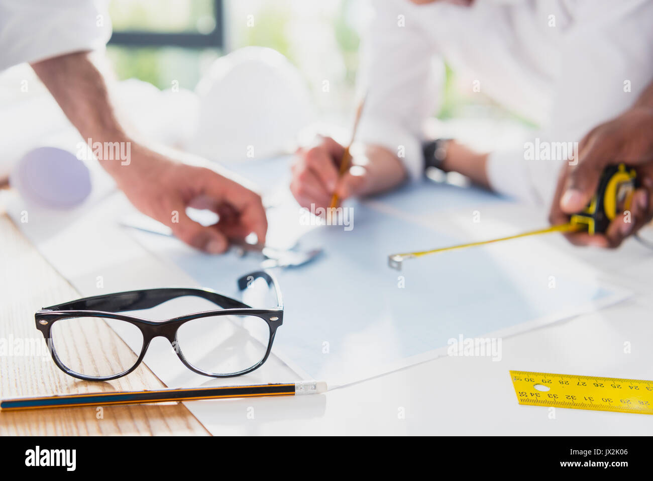 professional architects in formal wear working at modern office ...