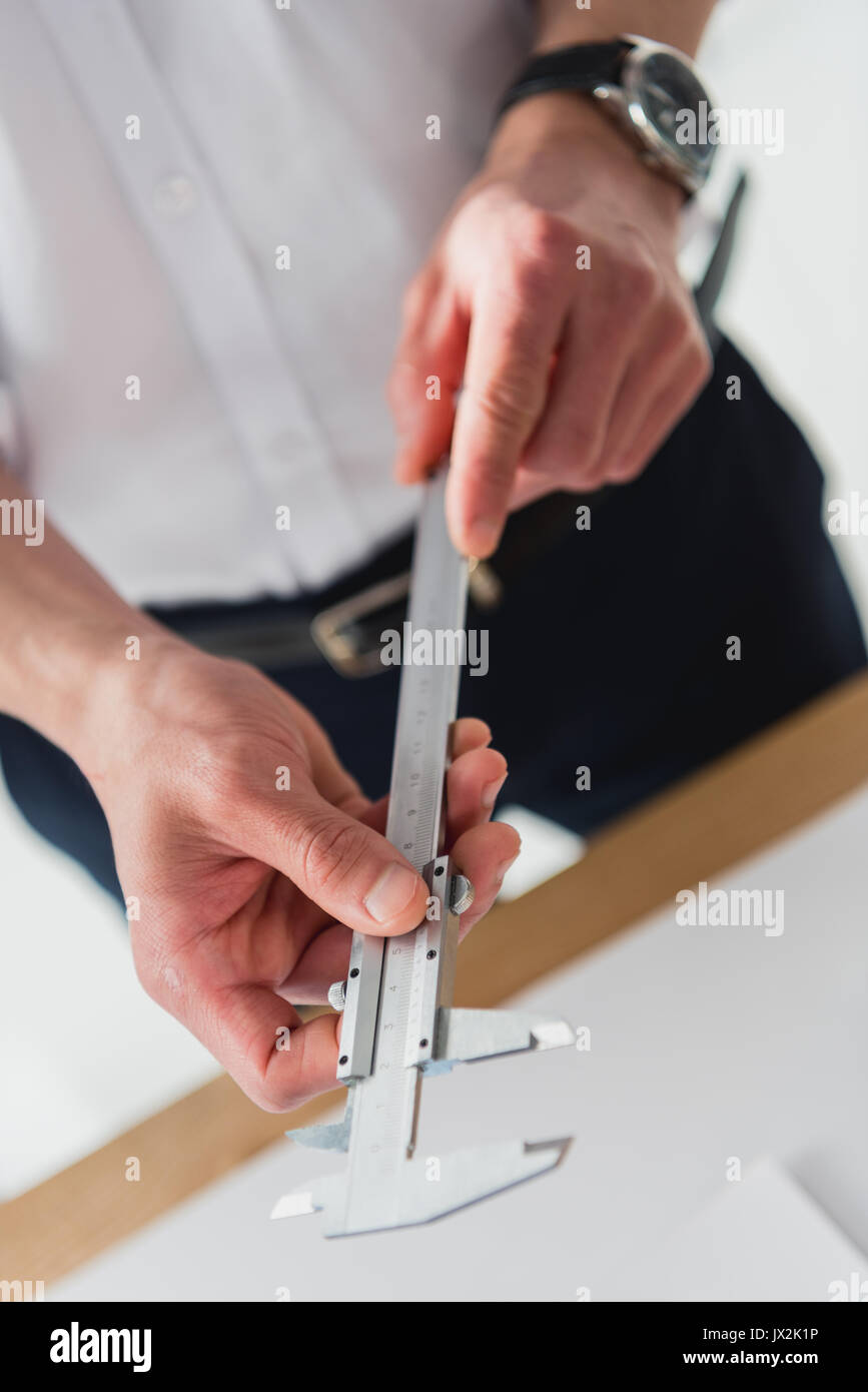 professional architect in formal wear working with tool at modern ...